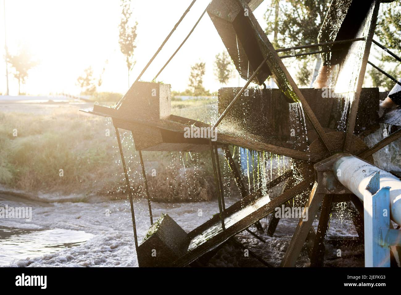 Close-Up Of Water Wheel By Promenade During Sunshining in village Stock ...