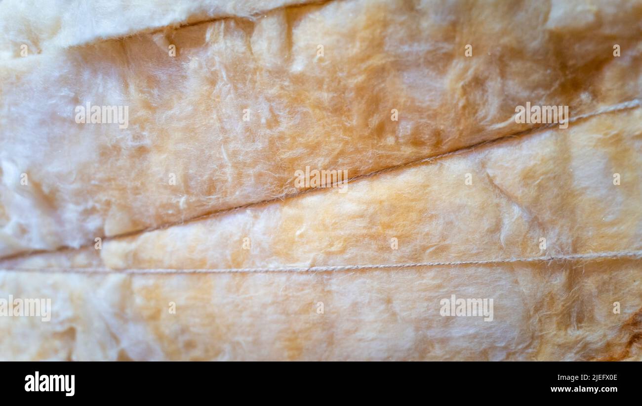 The roof is insulated with yellow glass wool. Insulation hemming with ...