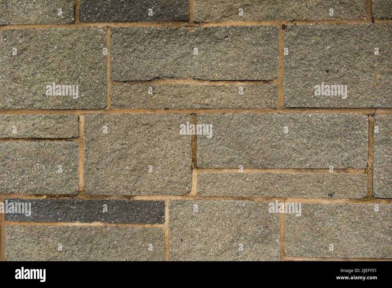 random new stone wall with one dark grey block Stock Photo - Alamy