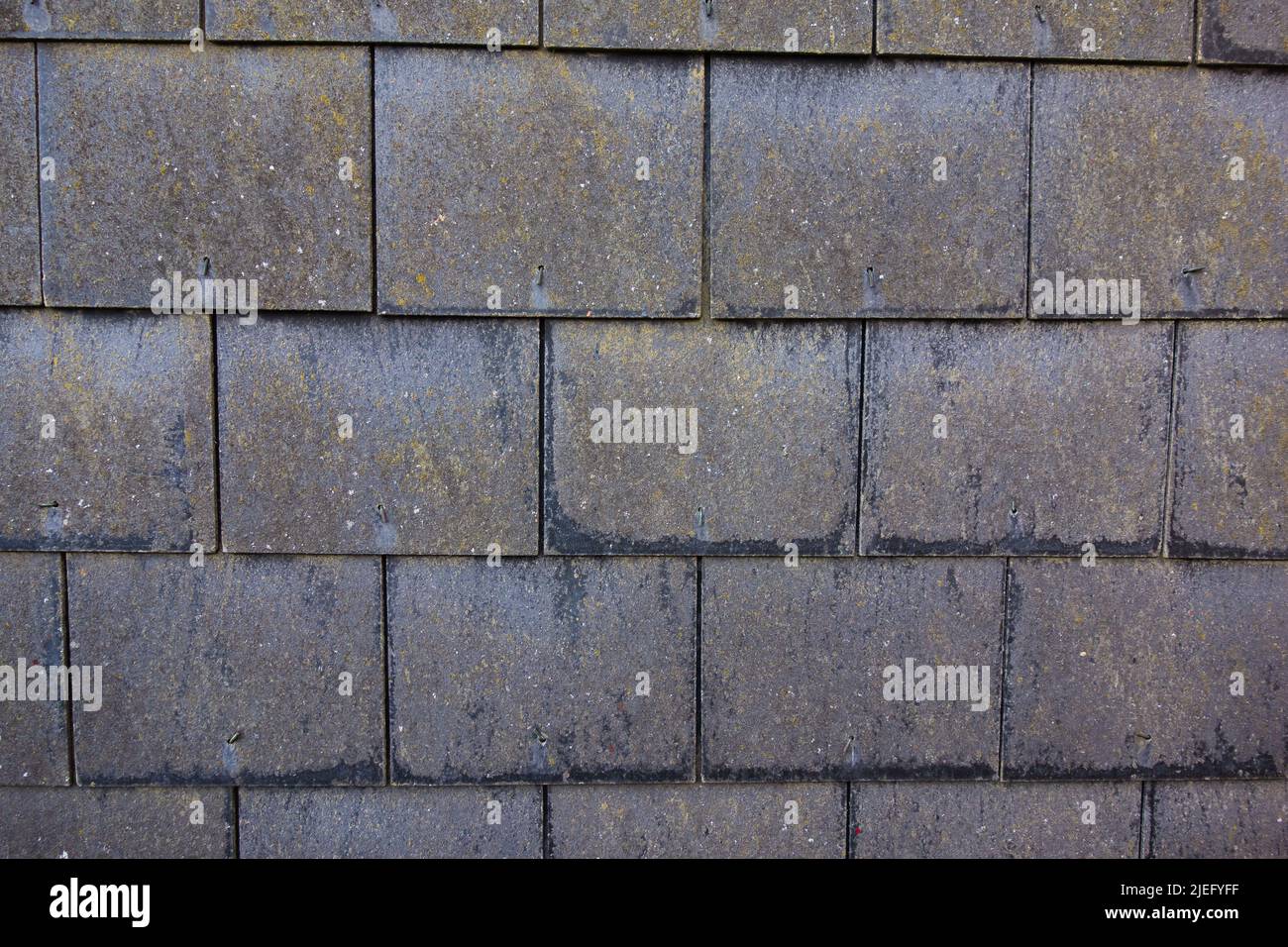 square slate grey roof tiles on a wall Stock Photo - Alamy