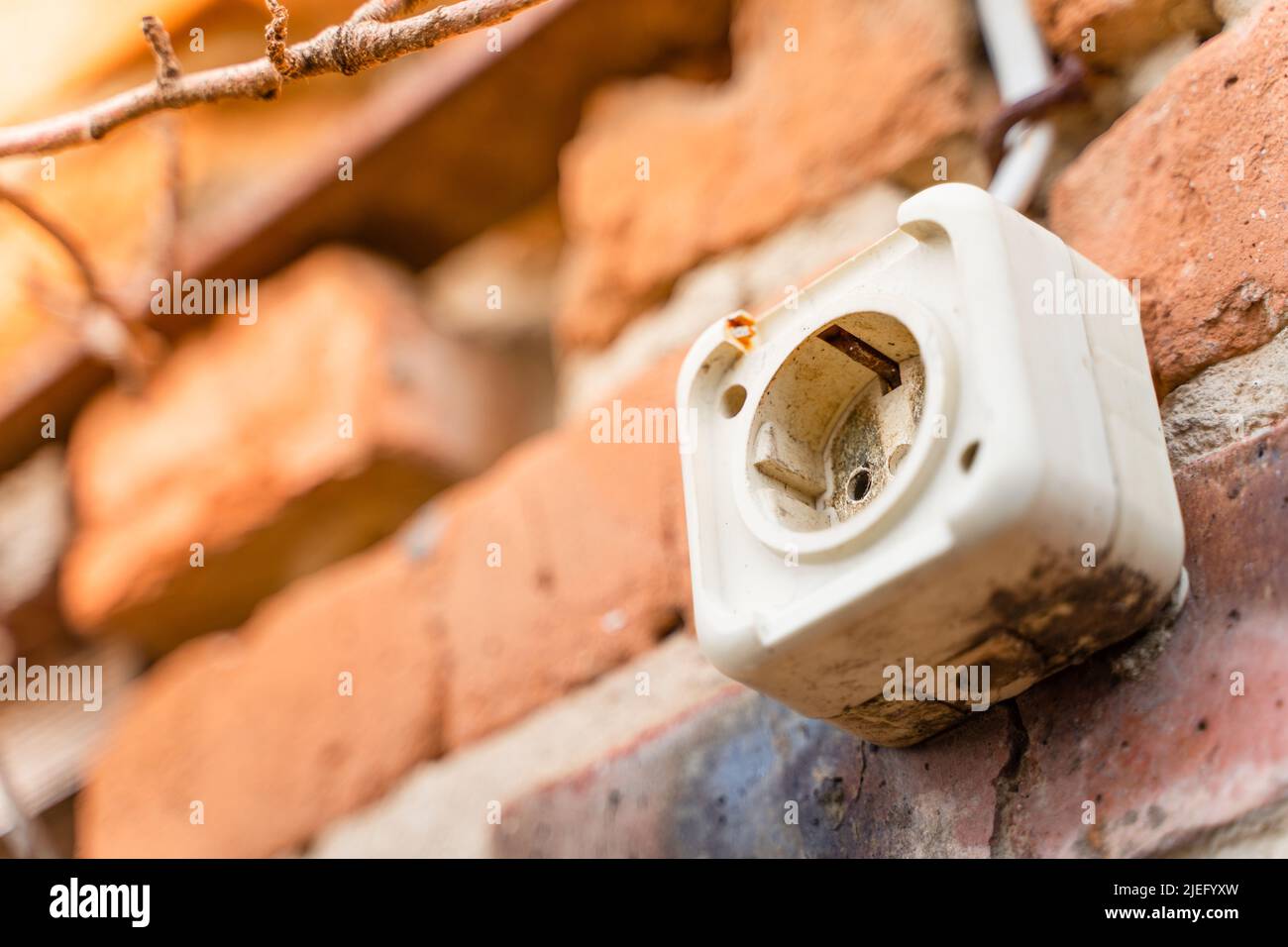 Outdoor plastic old socket without rain protection close-up on an old ...
