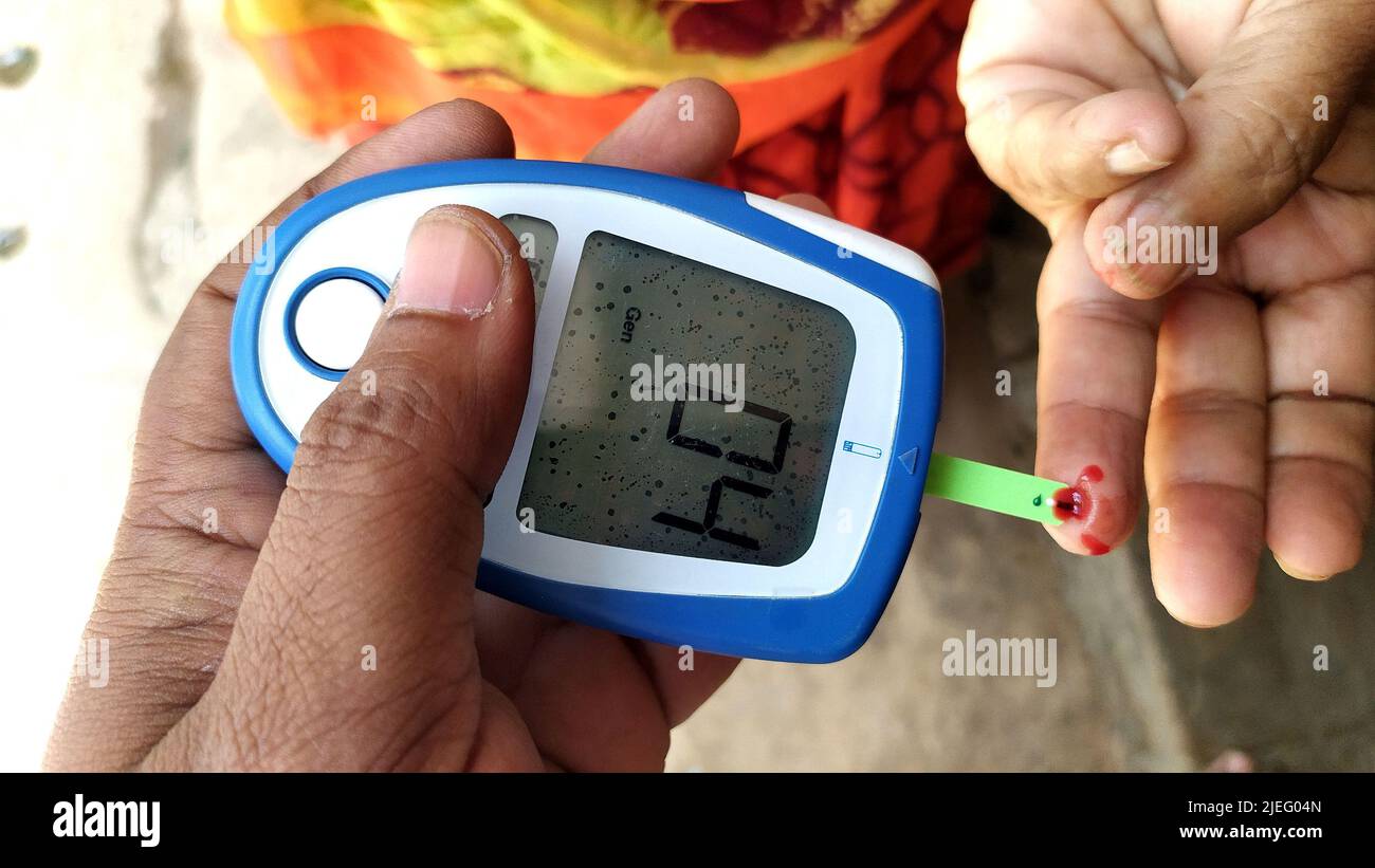 Diabetes machine in hand prick finger to make punctures to obtain small ...