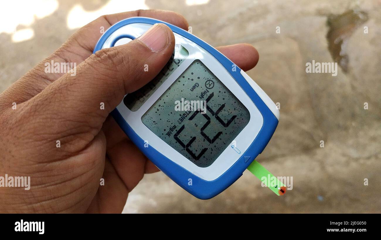 Diabetes machine in hand prick finger to make punctures to obtain small ...