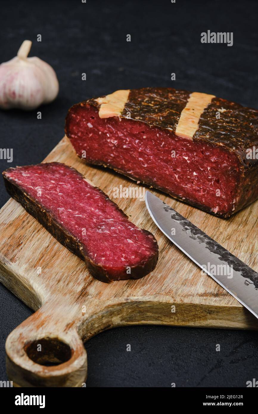 Rustic homemade cured beef ham on cutting board Stock Photo - Alamy