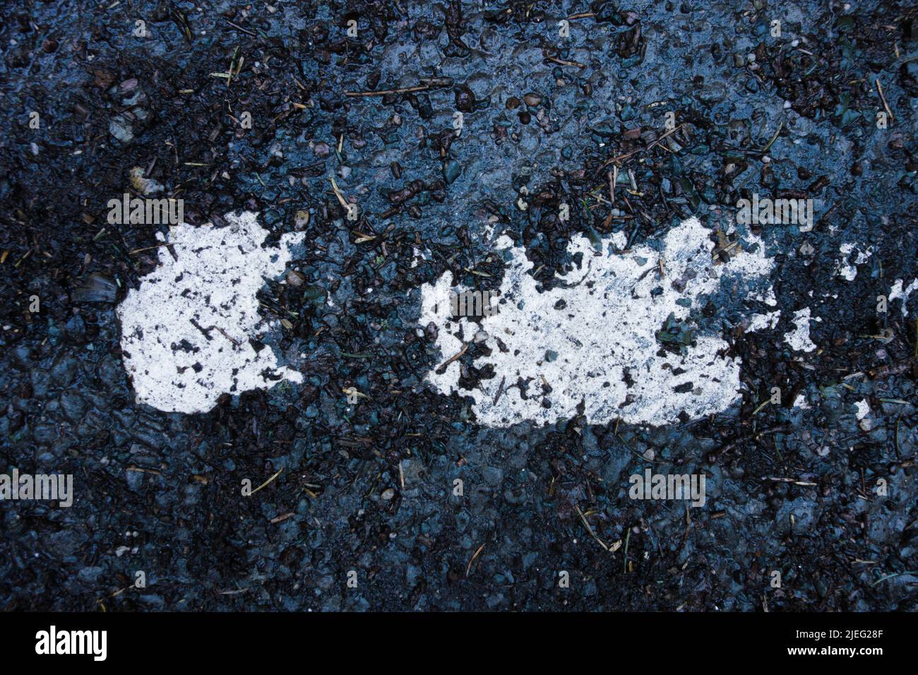 worn white road marking covered in dirt Stock Photo - Alamy