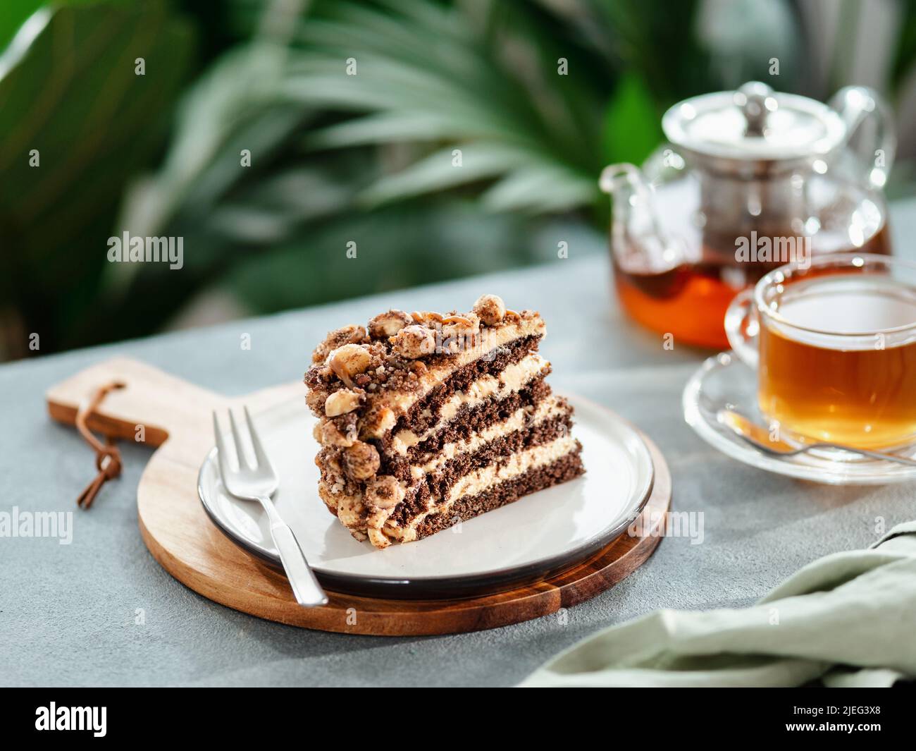 Perfect aesthetic layered cake with caramel and nuts on plate over gray ...