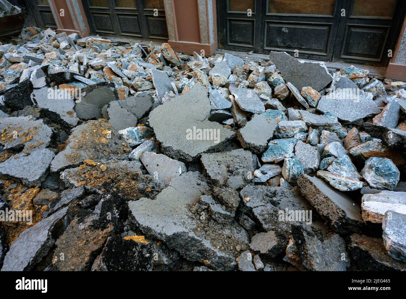 Cracked asphalt road with debris in the city Stock Photo - Alamy