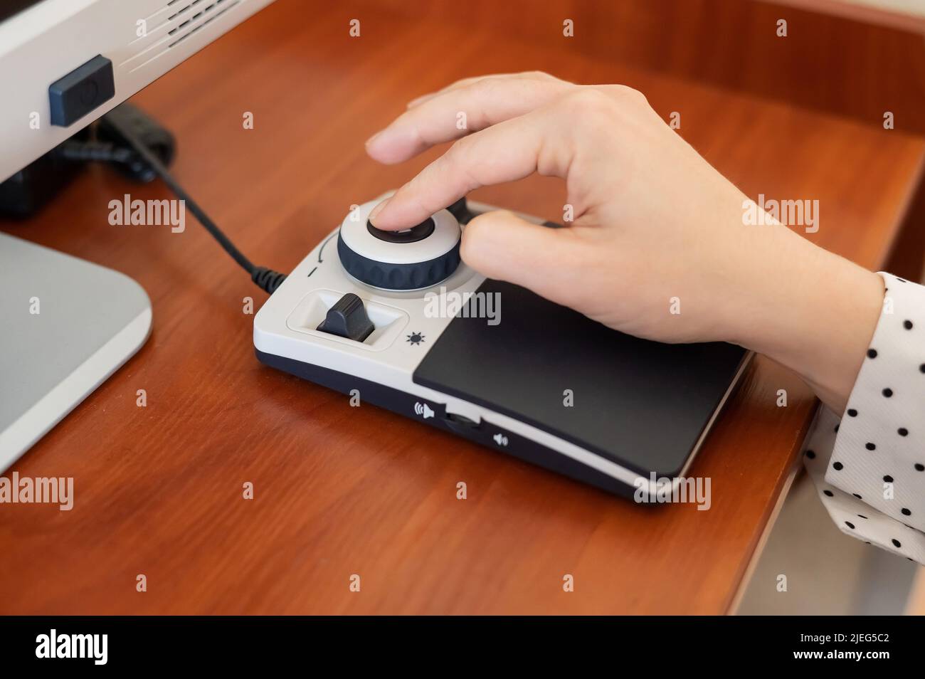 A woman uses a special magnification device for the visually impaired ...