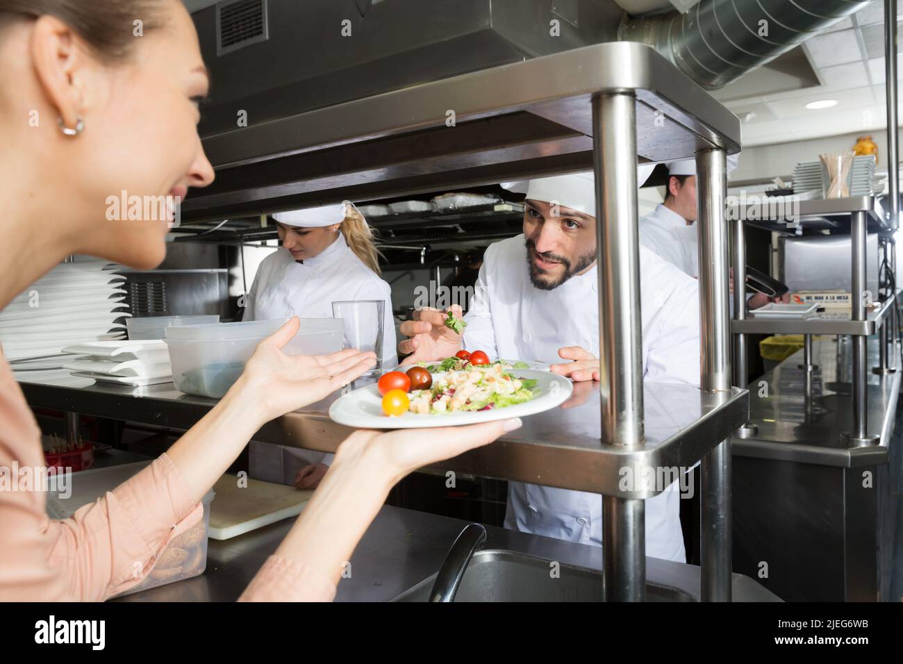 Staff of restaurant with head chef working Stock Photo - Alamy