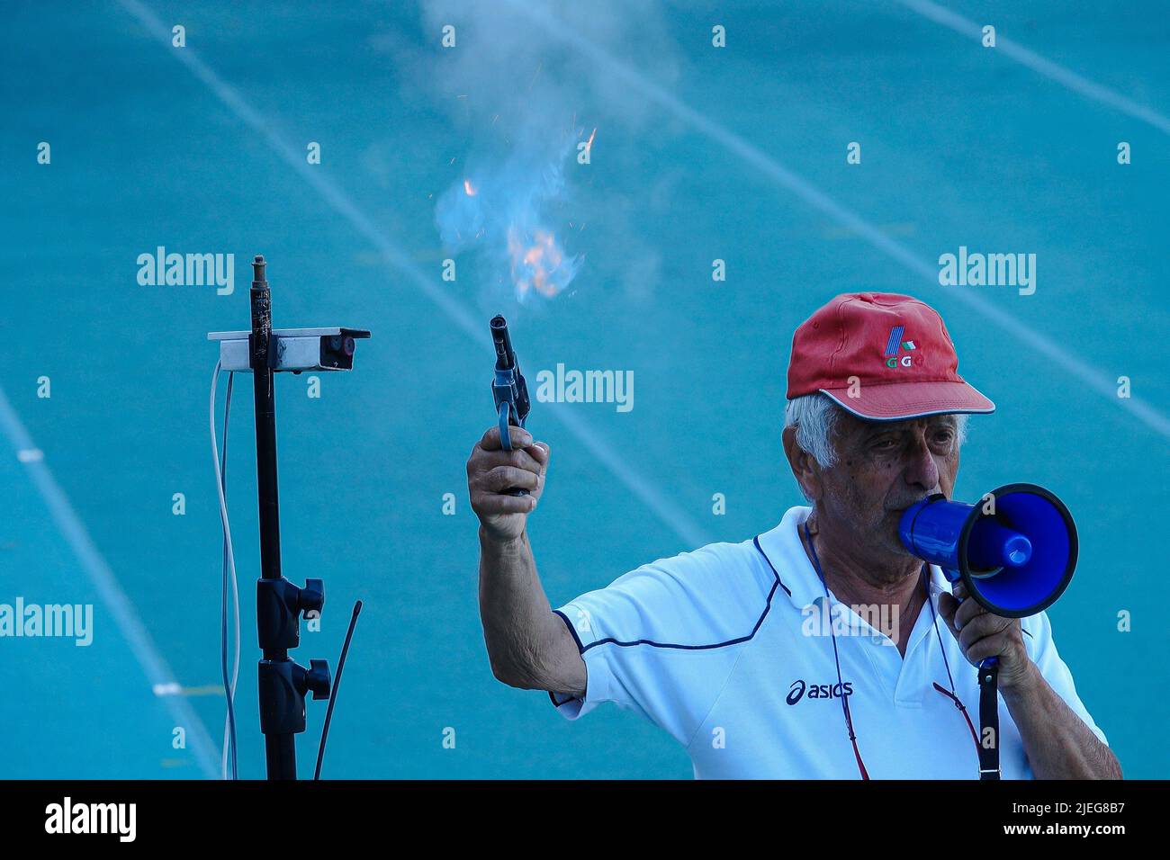Starting pistol being fired. Hand firing a gun for starting race. Milan ...
