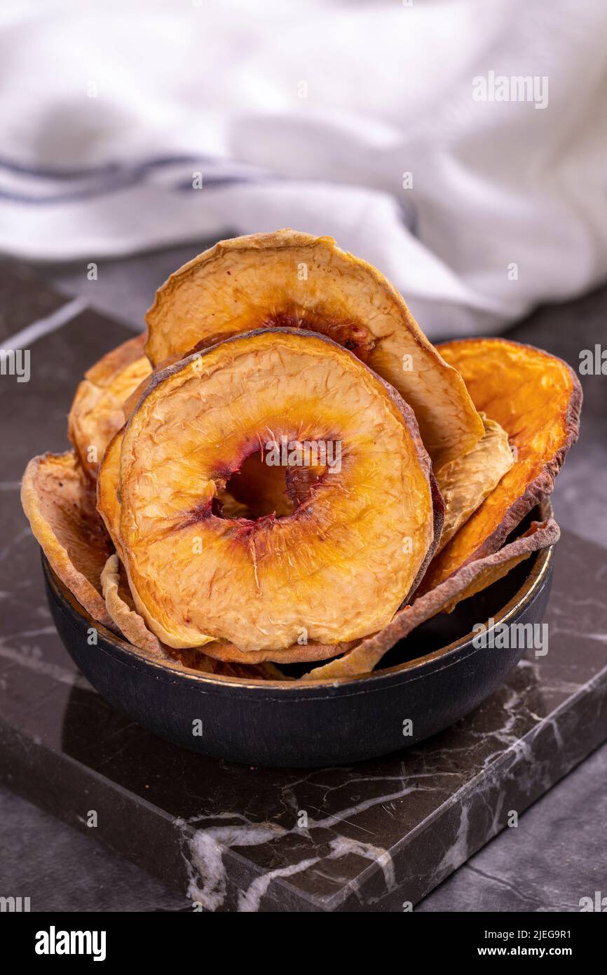 Dried peach slices. Sliced dried peaches on a dark background. Sun ...