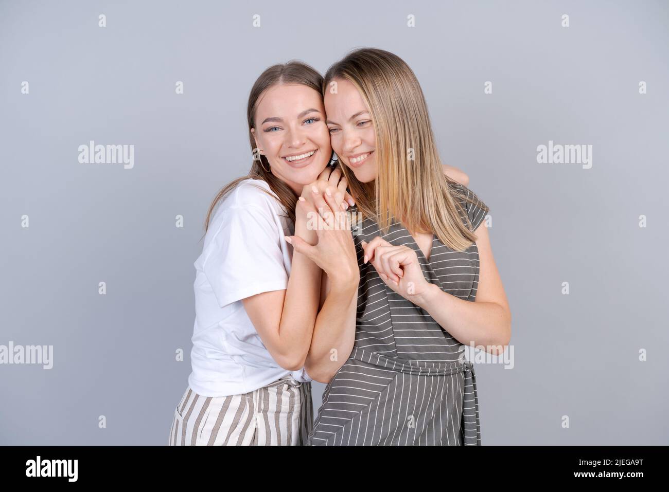 Close up photo amazing cute two people mom and daughter stand hugging ...