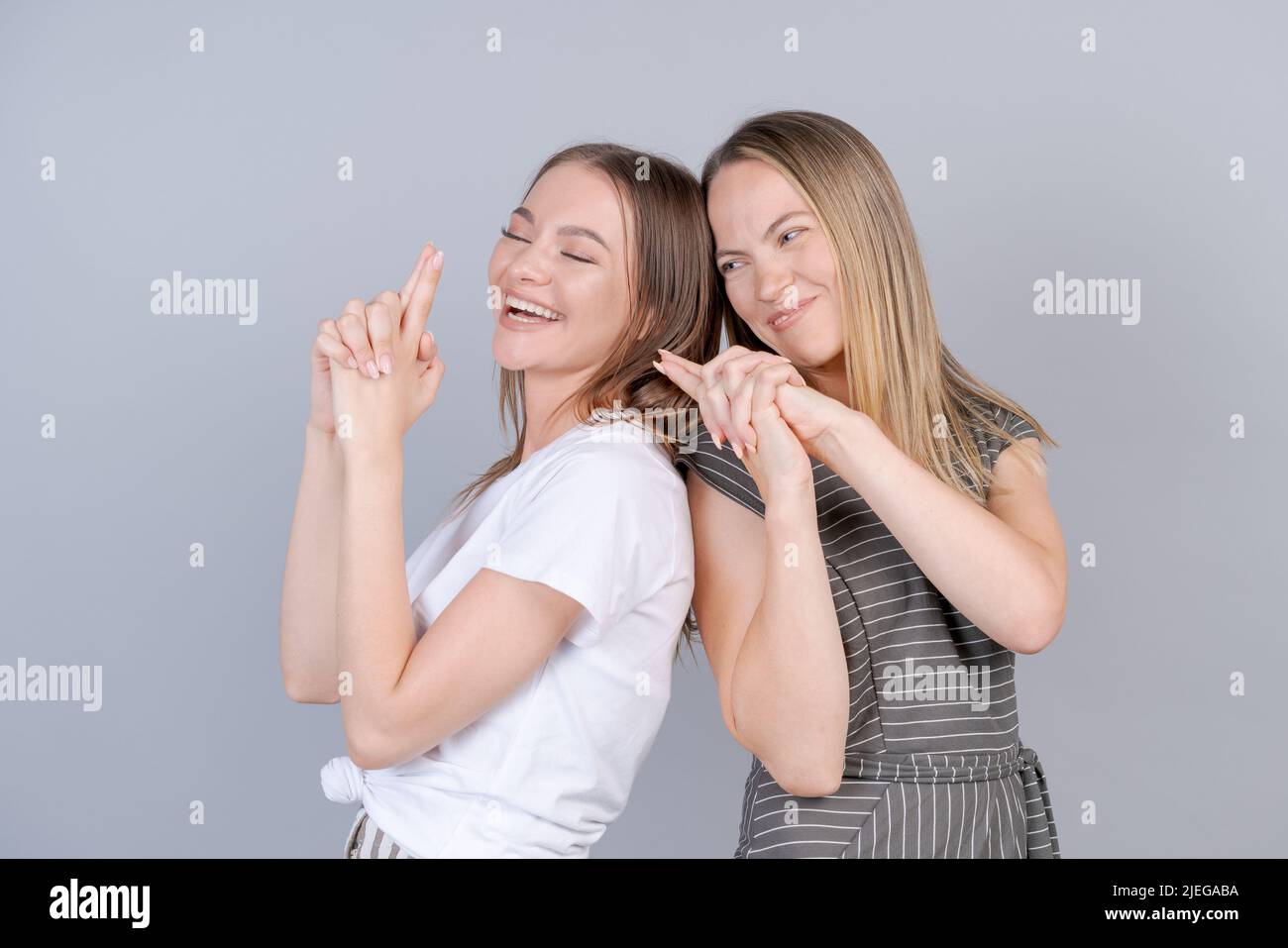 Mother and daughter are hugging and having fun together on background ...