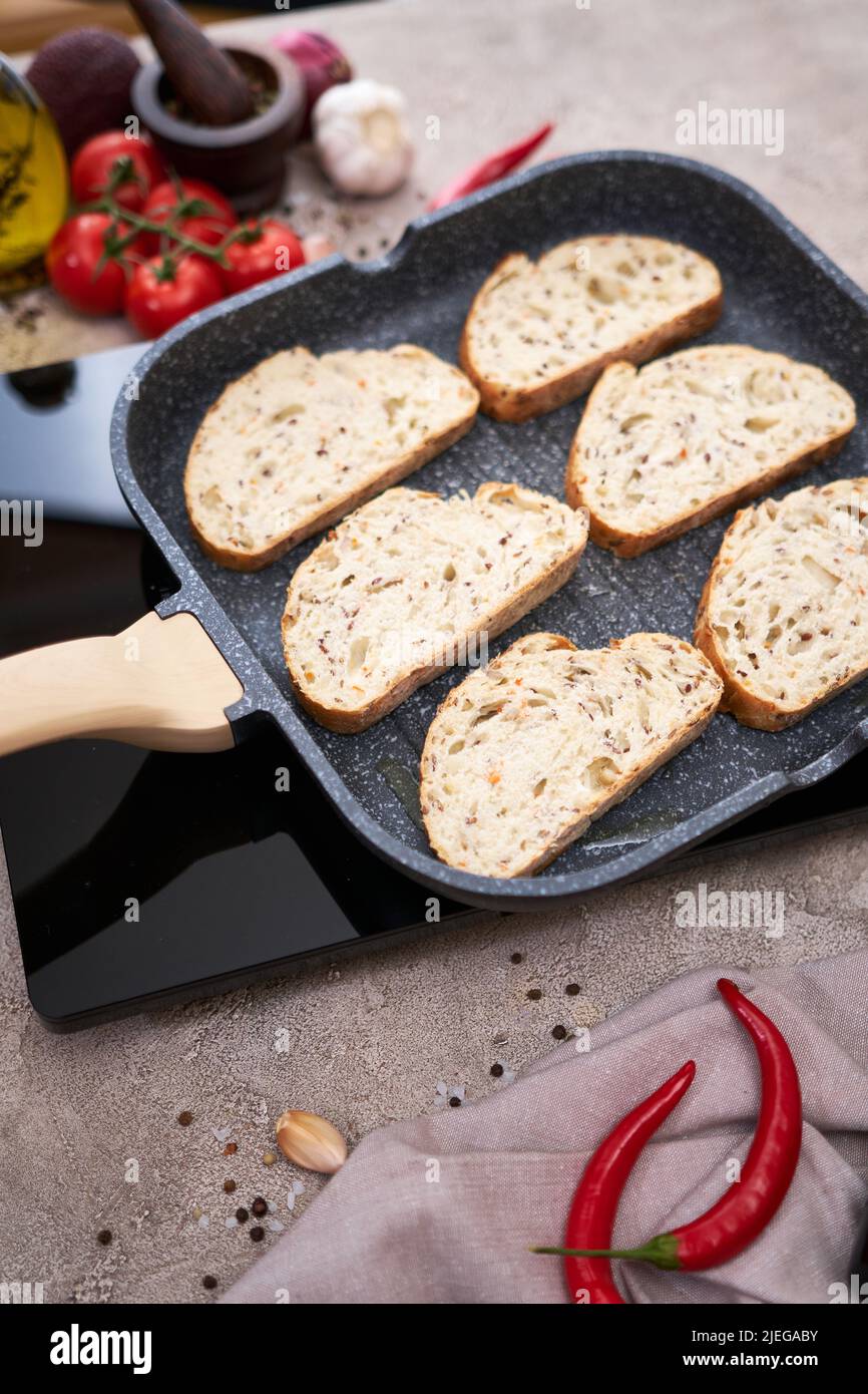 Sliced bread fried on grill frying pan at domestic kitchen Stock Photo ...