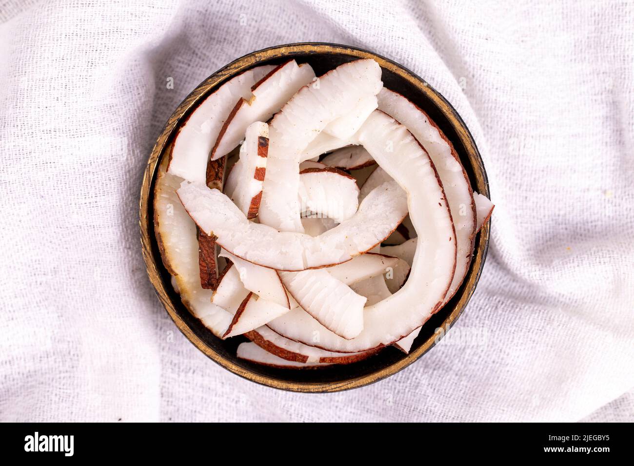 Dried coconut slices. Sliced dry coconut on a white background. Sun ...