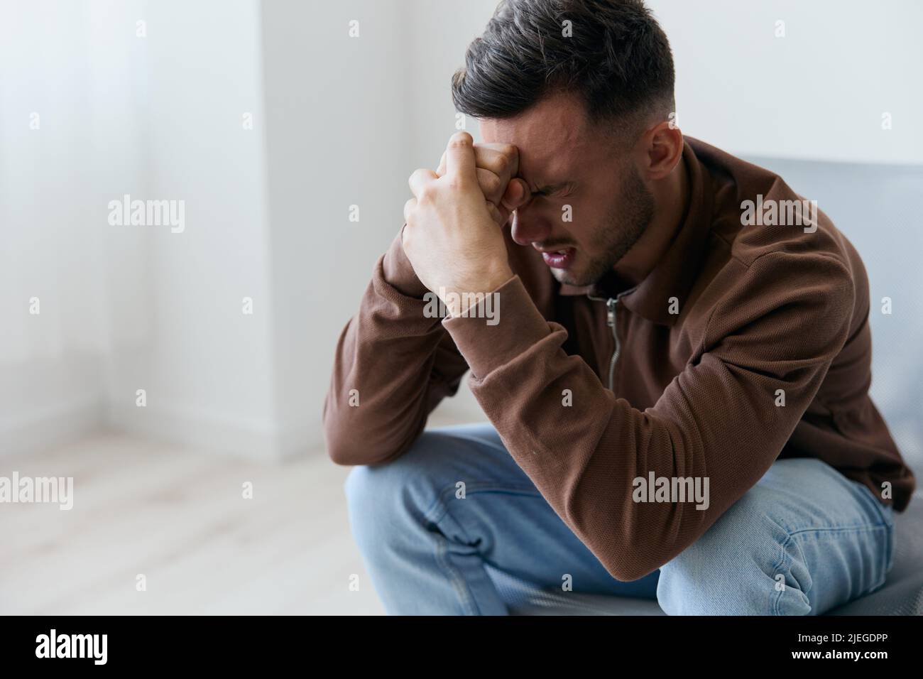 Suffering from bad relationship break up young man guy folded hands ...