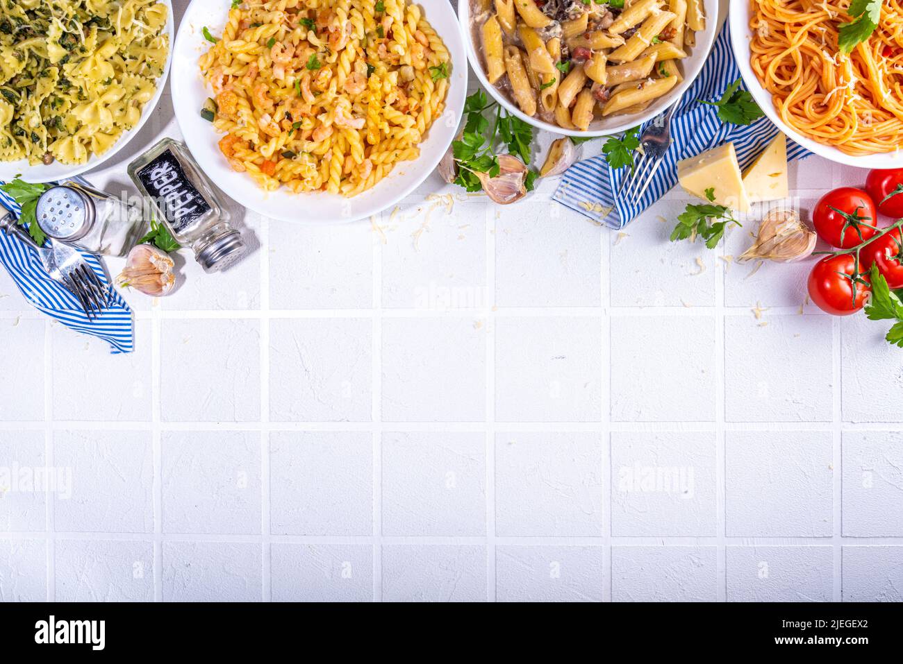 Set of pasta with different sauces on white tiled background. Spaghetti ...