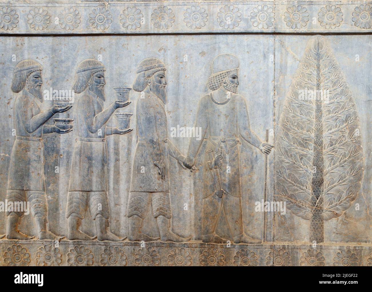 Ancient wall with bas-relief with assyrian foreign ambassadors with ...
