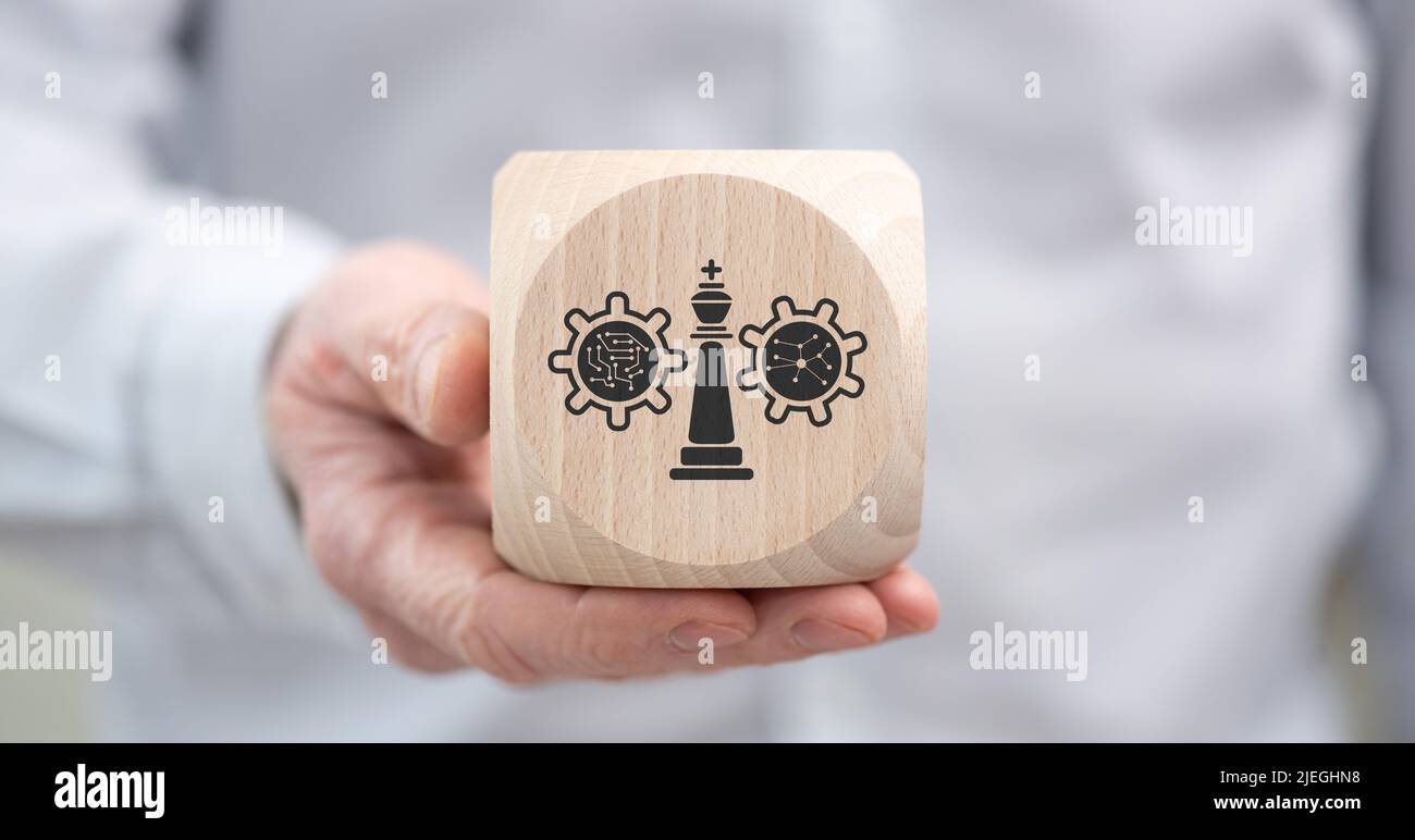 Hand holding a wooden cube with symbol of digital strategy concept ...