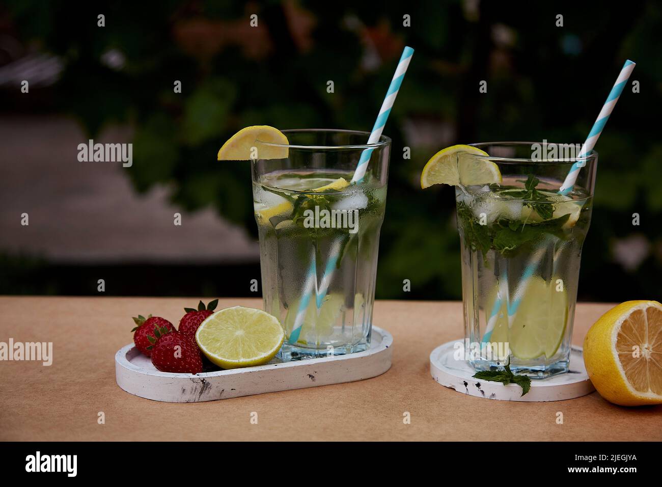 Colorful infused water with lemon, lime, mint and strawberries. Healthy ...