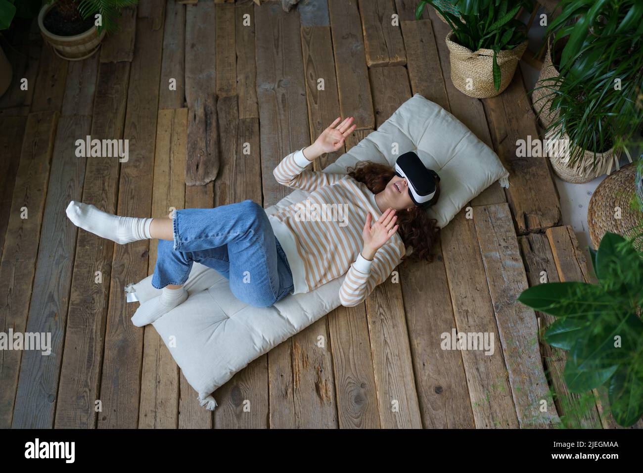 Shocked by VR young woman in virtual reality glasses watching 360 ...