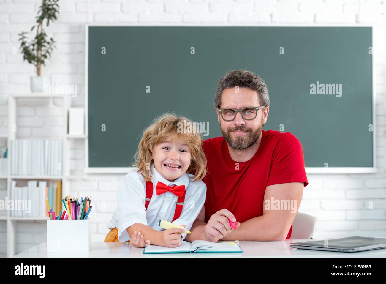 Pupil kid student and teacher tutor in classroom at school lesson. Cute ...