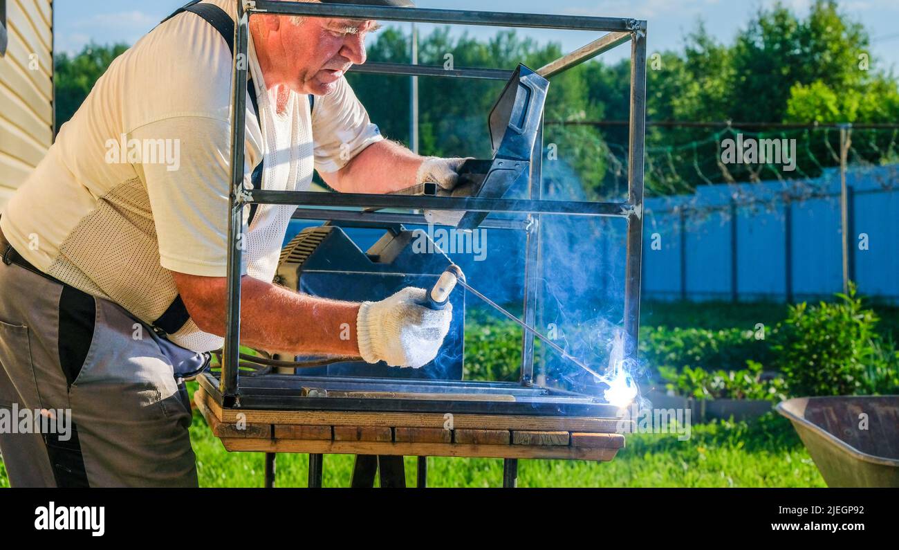 Welder welds metal construction sparks hi-res stock photography and ...