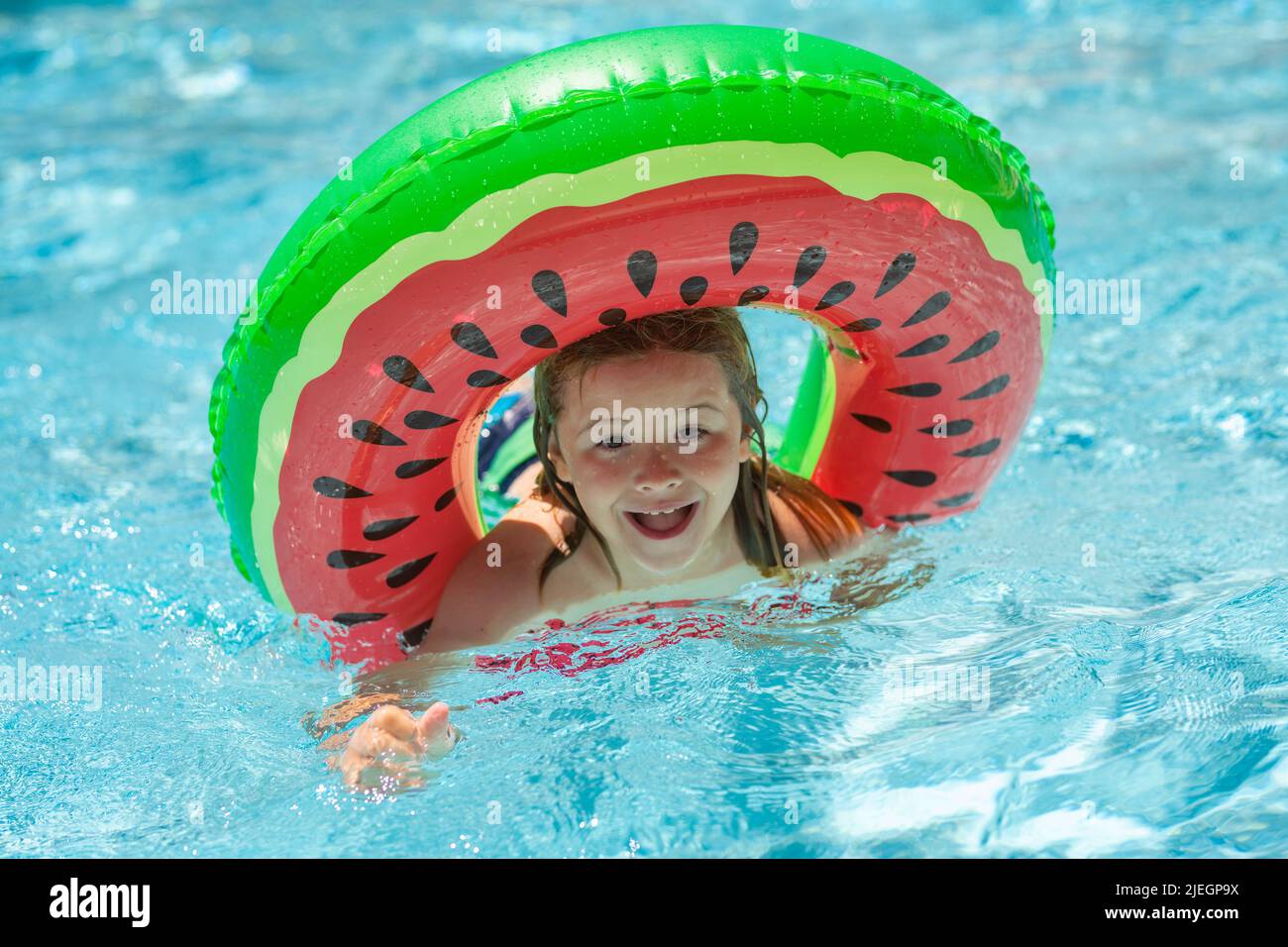 Child boy swim with float ring in swimming pool. Kids summer holidays ...