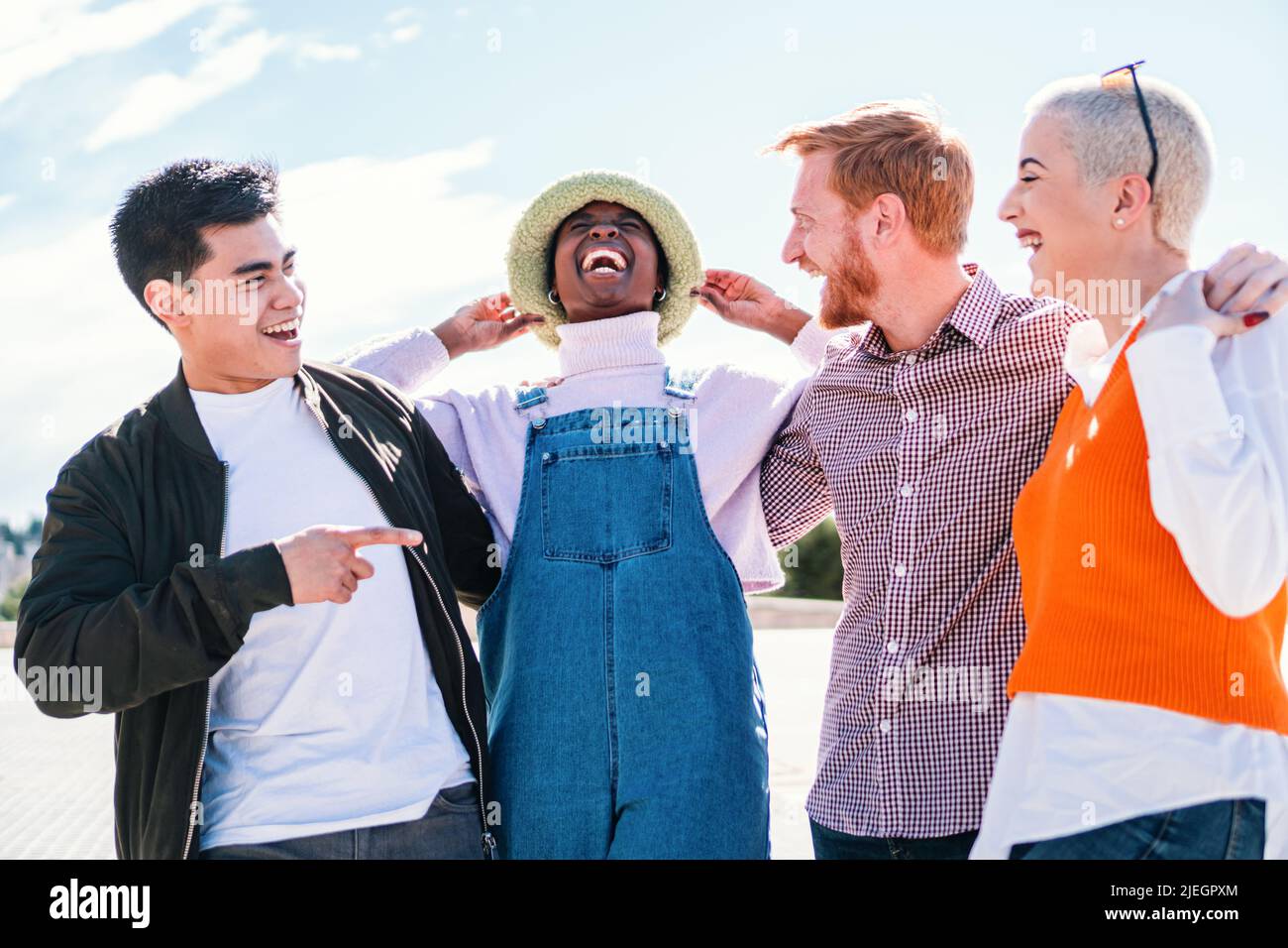 Portrait of cheerful young friends talking and laughing. sharing good ...