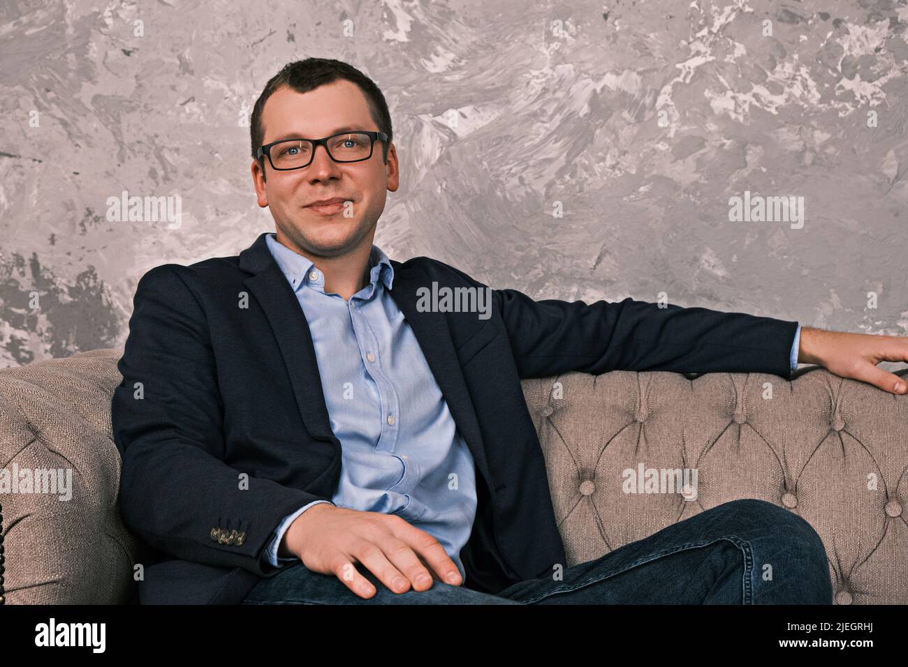 Portrait of young caucasian smiling businessman wearing jacket and ...