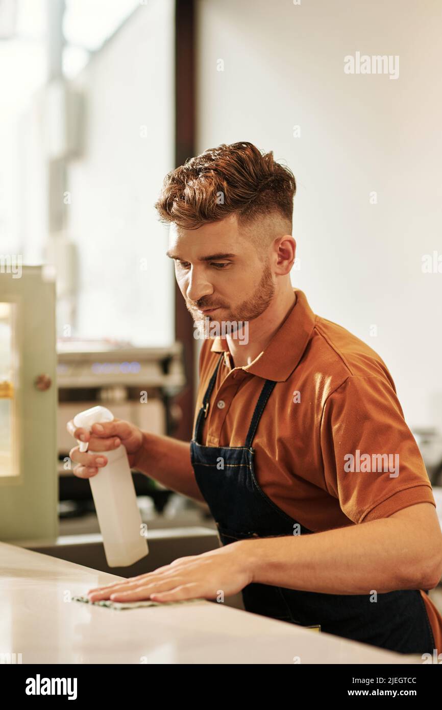 Bartender cleaning counter with spray detergent Stock Photo - Alamy