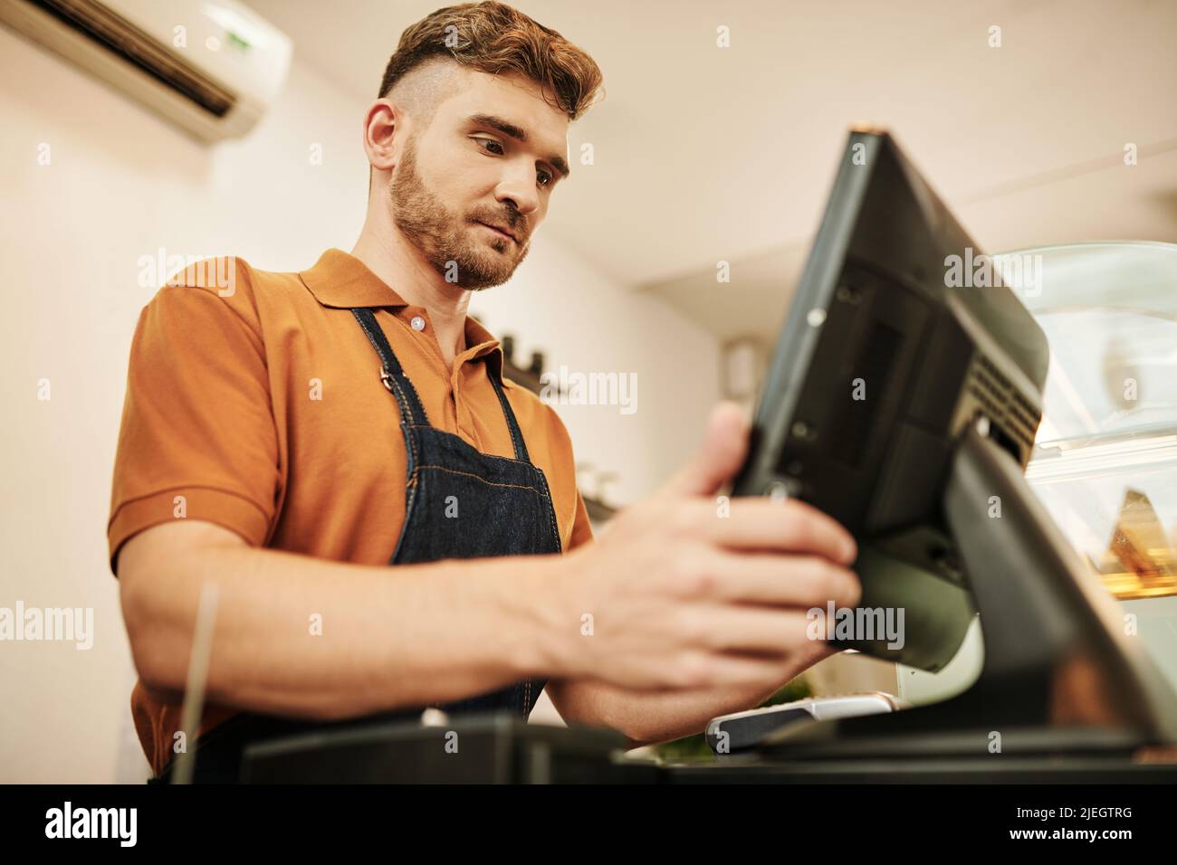 Cafe waiter sending order to kitchen via cash register terminal Stock ...