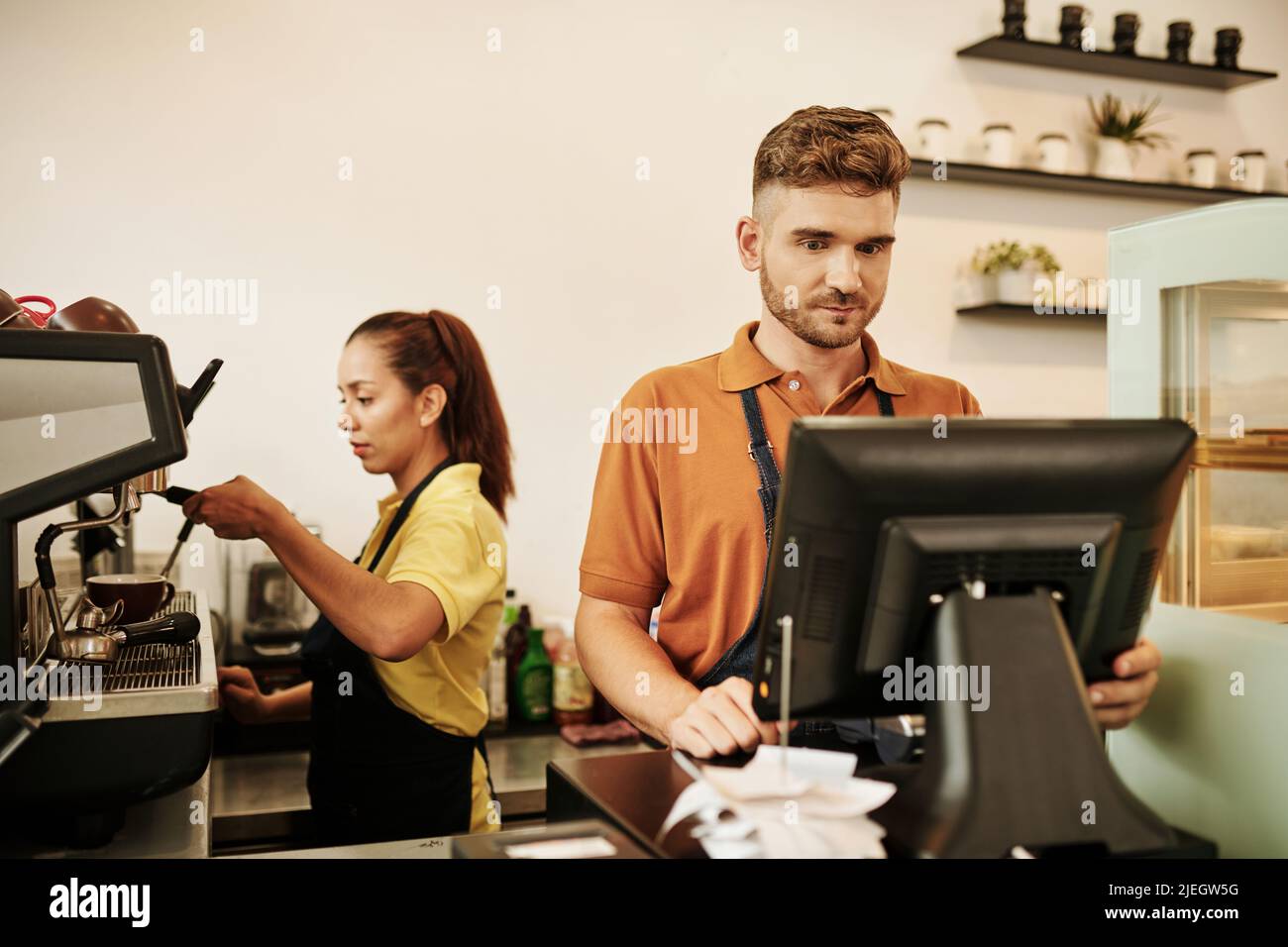 Coffeeshop owner working at cashier desk when b as tostada making ...