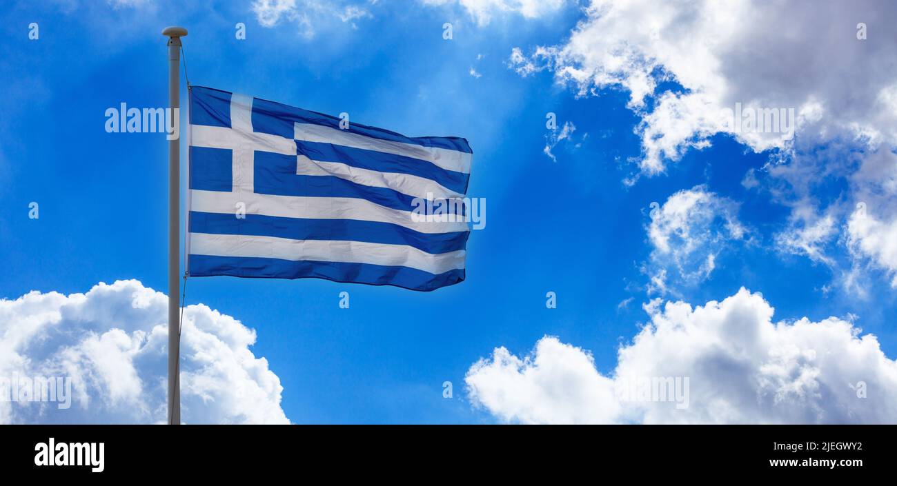 Greek national official flag on flagpole waving in the wind. Greece ...