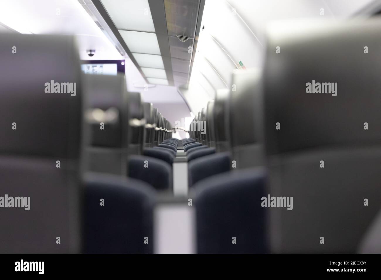 An empty cabin of the aeroexpress train without passengers. Soft seats ...