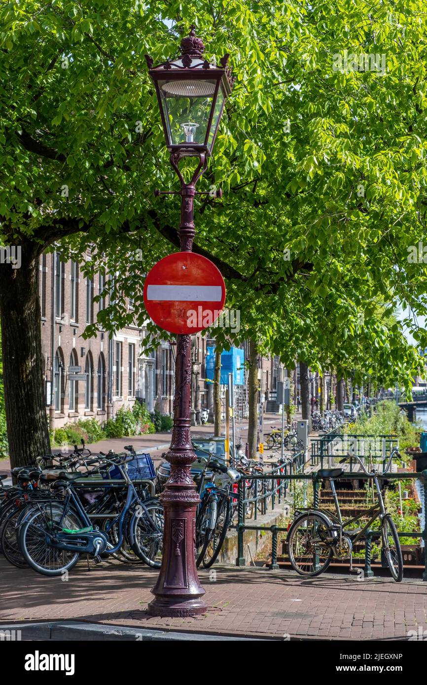 Stop sign in Amsterdam Netherlands Holland. Bikes parked on a canal ...