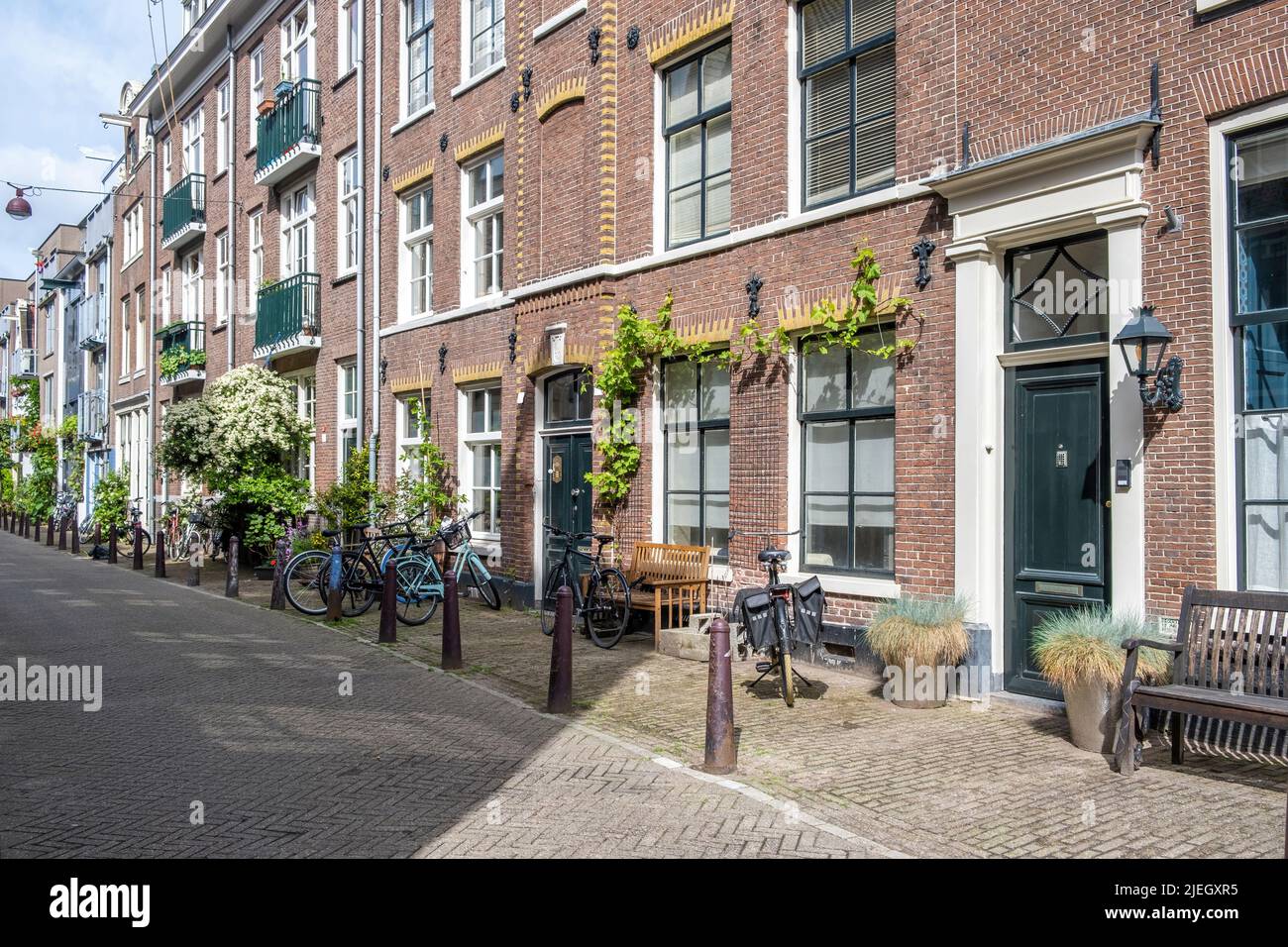 Amsterdam city paved pedestrian street. Traditional red brick wall ...
