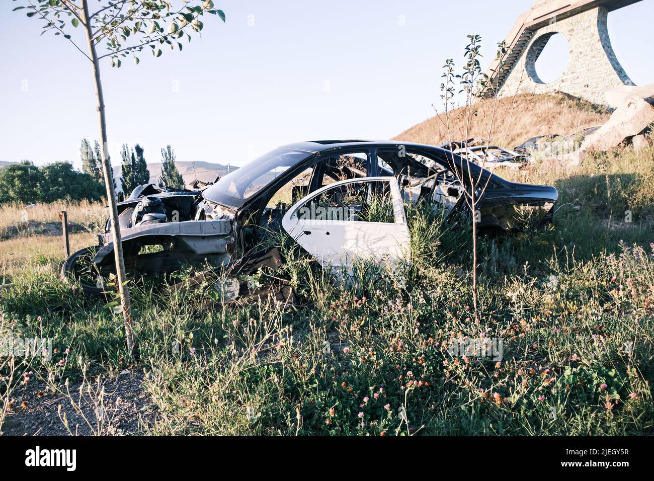 Car dump, scrap metal. Close-up of an old abandoned car in a junkyard ...