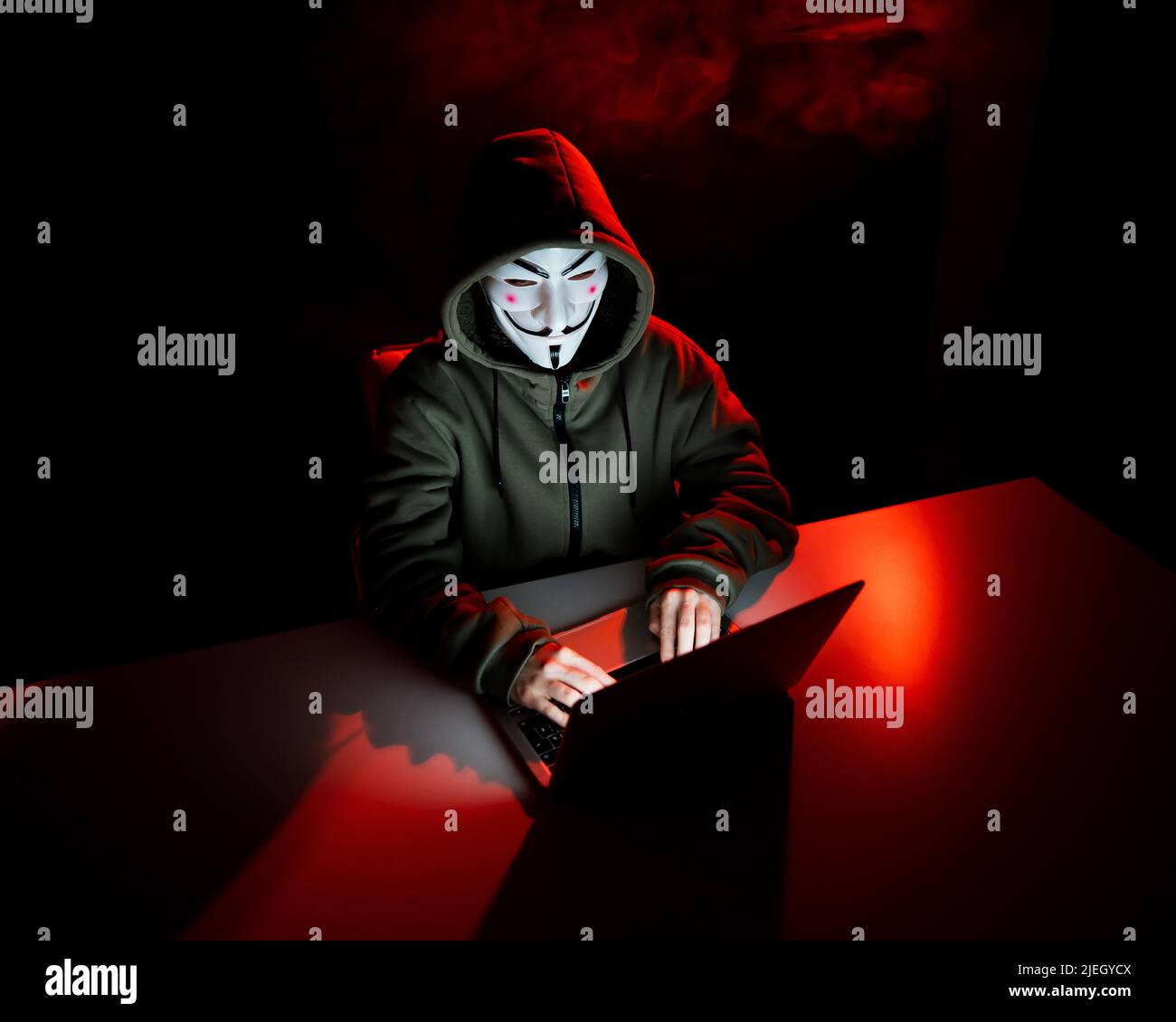 June 5, 2022 Novosibirsk, Russia: Anonymous in a hood is typing on a ...