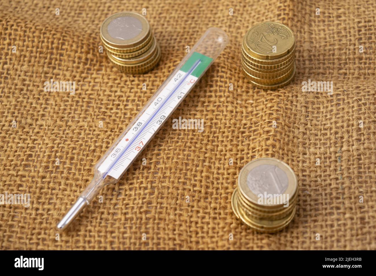 concept of economics of healthcare with a thermometer and the money ...