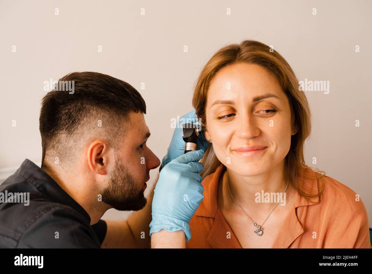 Otoscopy of ears with otoscope. ENT doctor. Consultation with ...