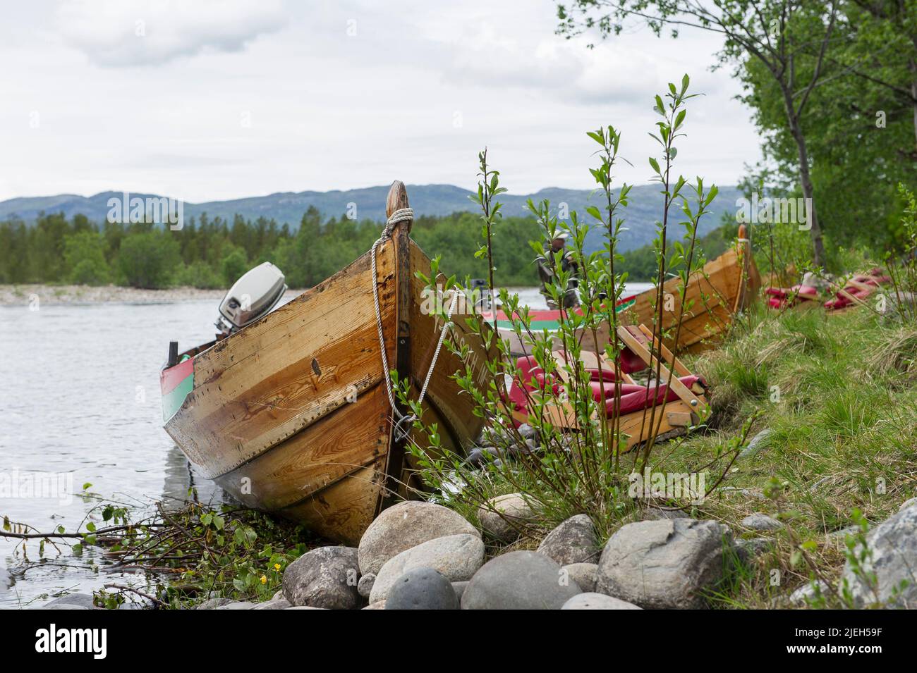 Wooden canoes to explore the Norwegian rivers Stock Photo - Alamy