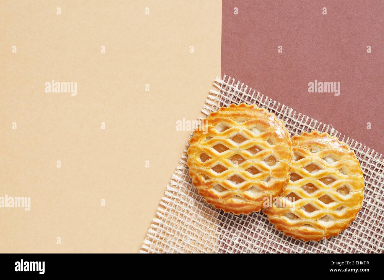 Lattice topped pastries with an apple filling on burlap located on two ...