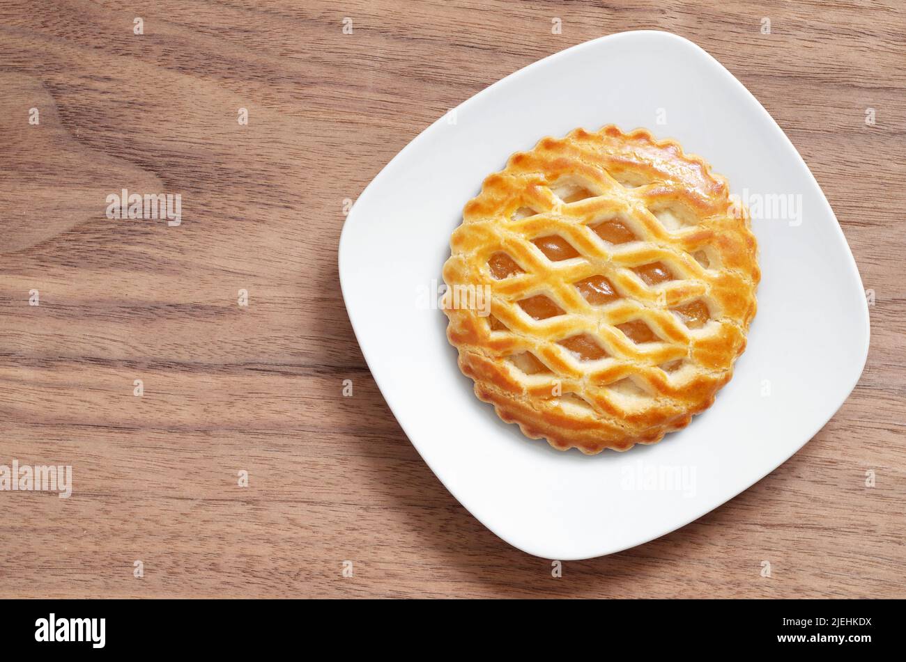 Round Apple Lattice Cake in plate on wooden background, top view with ...
