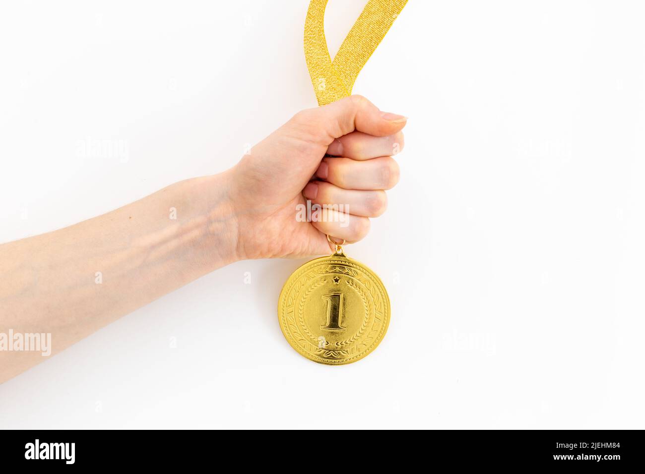 Winner and success concept. Hand holds gold medal trophy Stock Photo ...