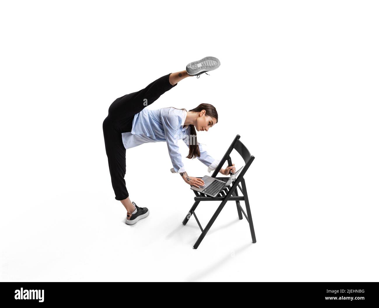 Portrait of motivated female employee working on laptop isolated over ...