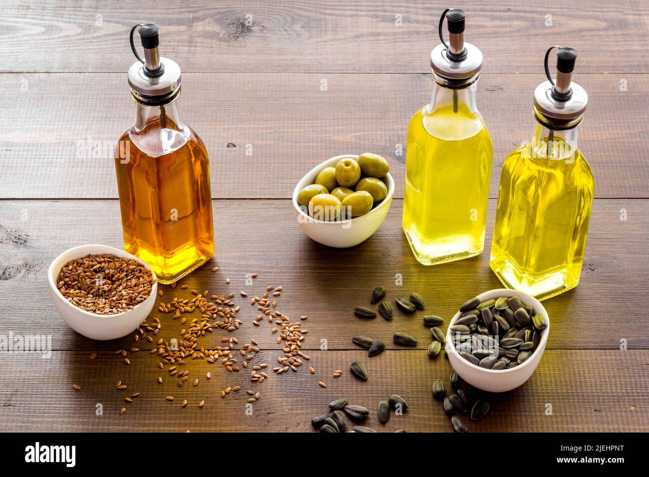 Bottles of vegetarian cooking oil - sunflower olive and sesame oil with ...