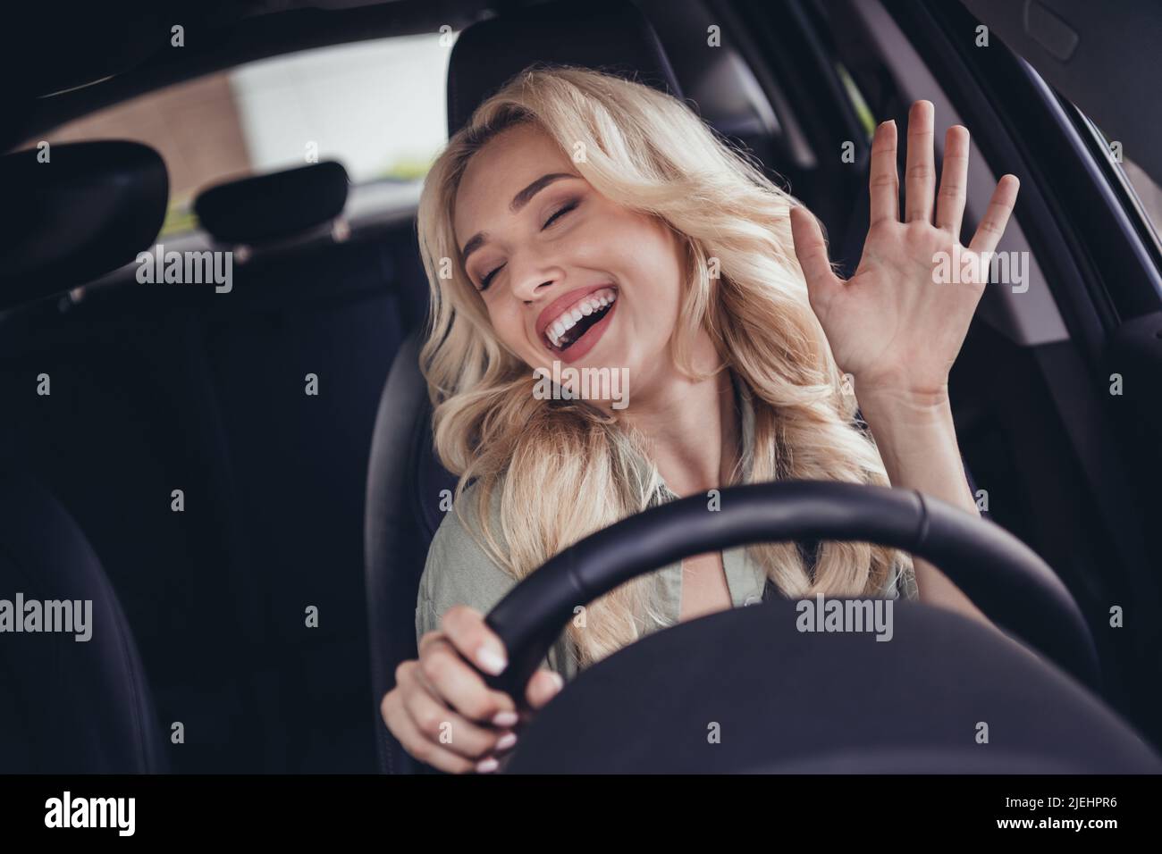 Portrait of positive nice girl sitting driver seat hold wheel have good ...