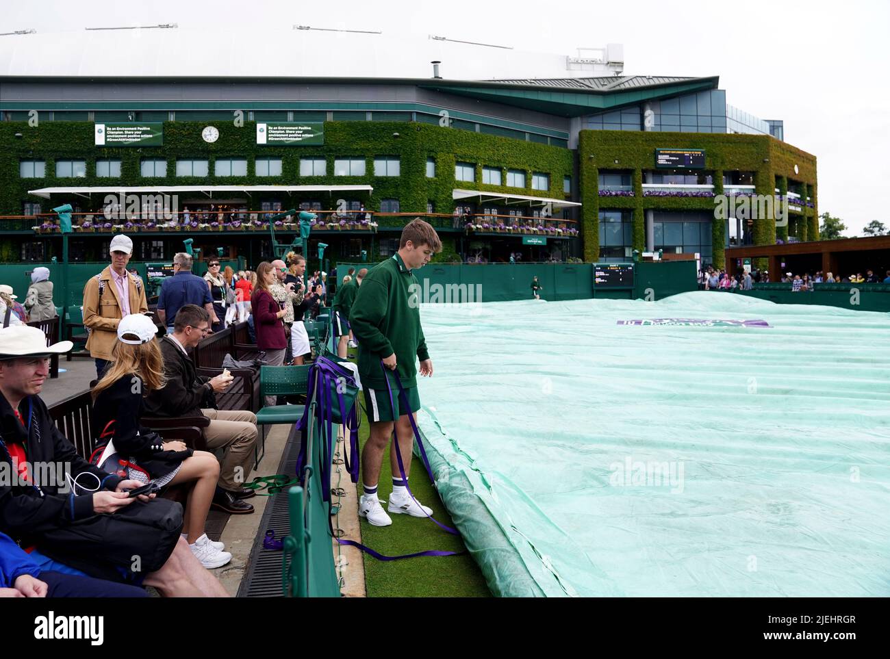 Rain covers are pulled across court seven on day one of the 2022 ...