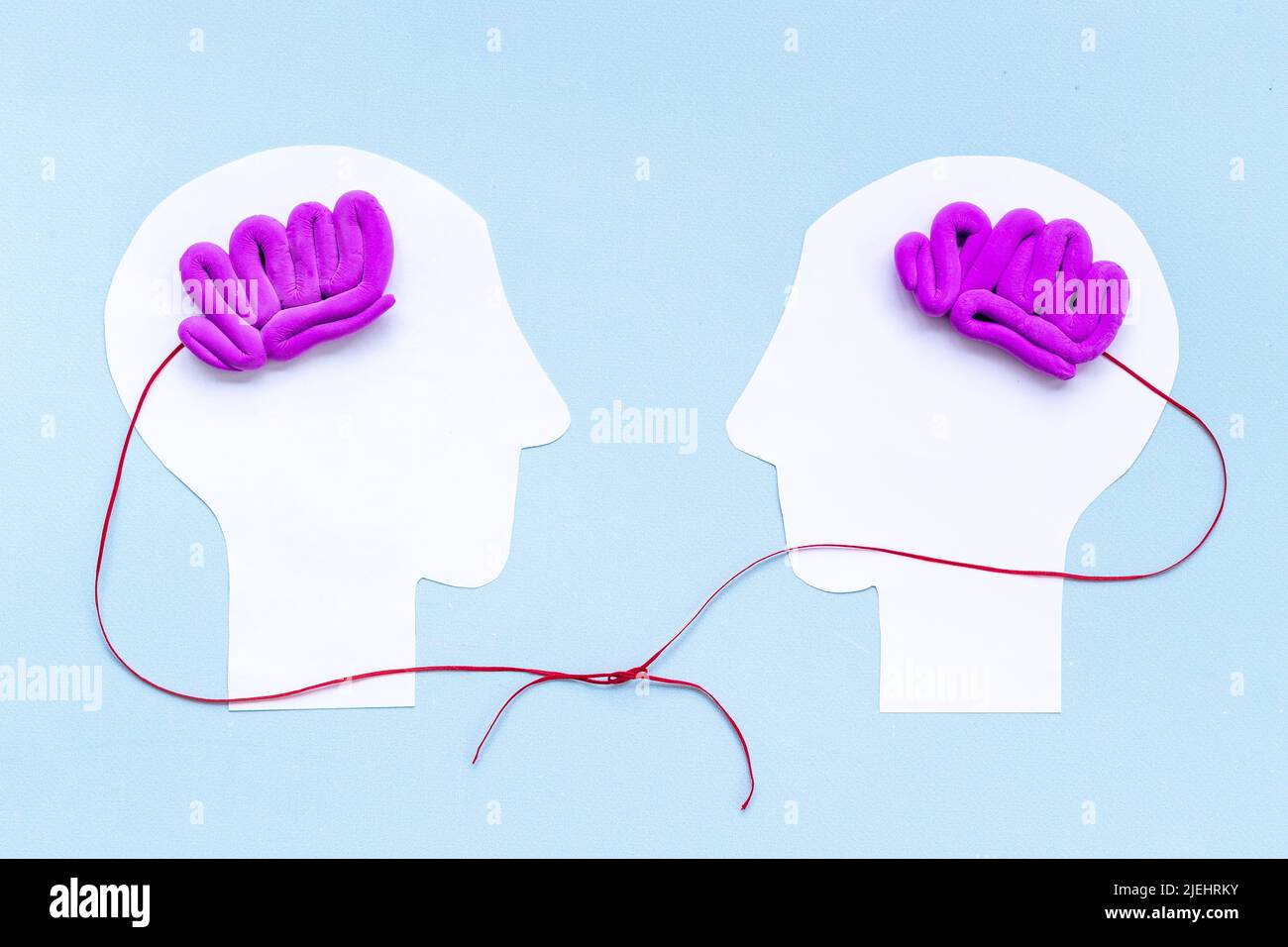 Human connection and communication. Brain on two paper human heads ...
